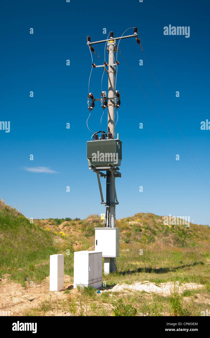electric pylon with isolators on blue sky background Stock Photo - Alamy