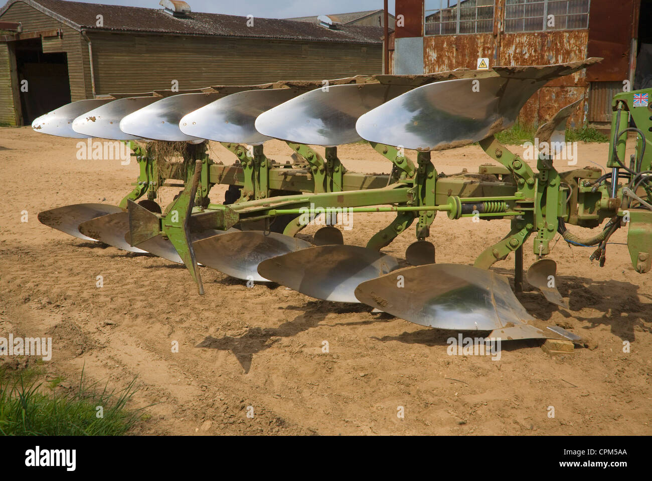 Steel blades modern plough in farmyard Stock Photo - Alamy