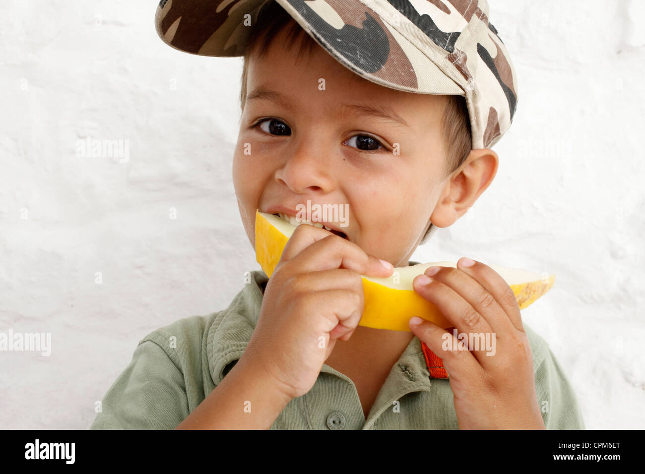 CHILD EATING FRUIT Stock Photo - Alamy