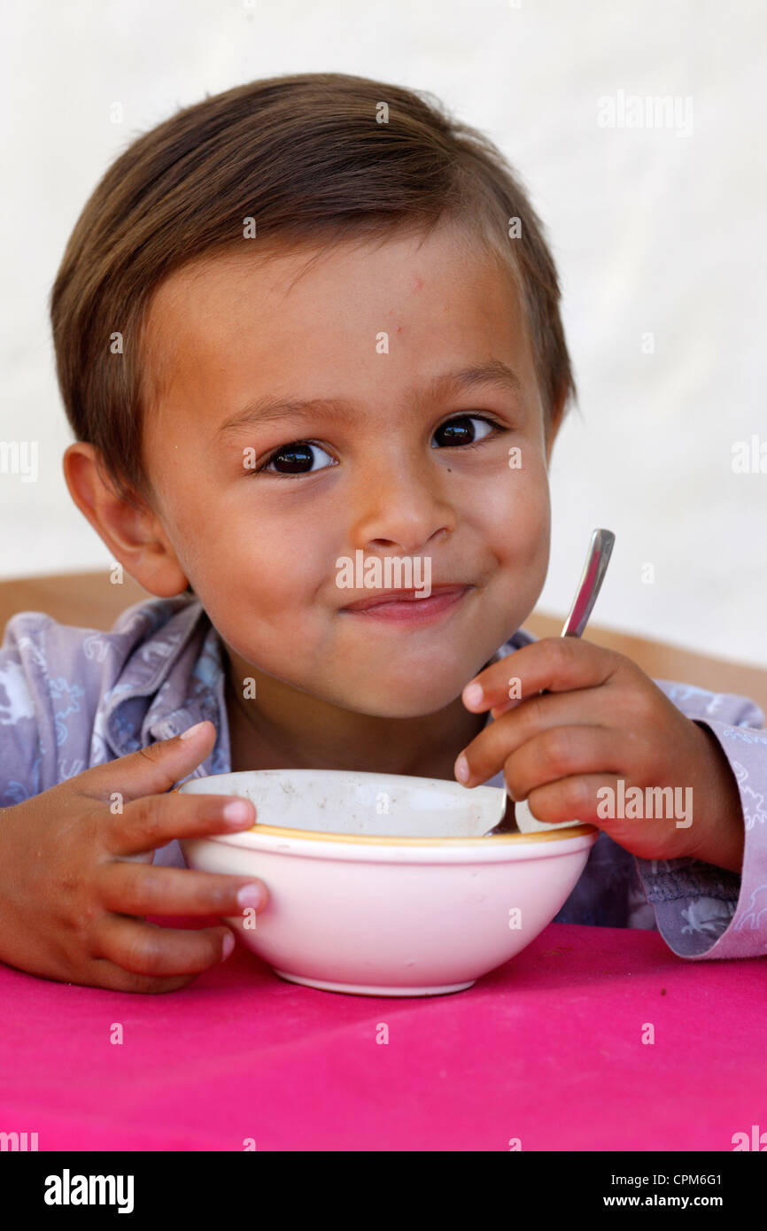 CHILD EATING BREAKFAST Stock Photo - Alamy