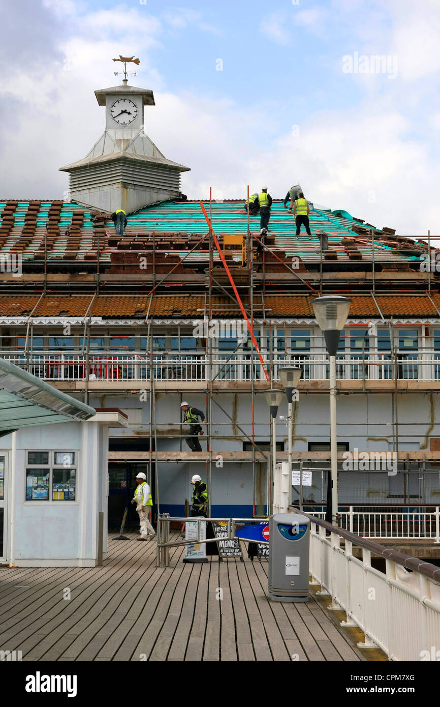 Workmen replacing a tiled roof on the Pier entrance at Bournemouth ...