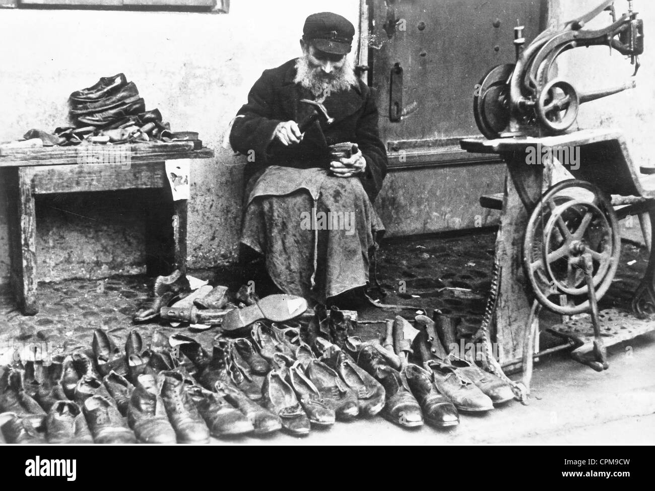Portrait of a Jewish cobbler at work in a Ghetto in Poland, 1941 (b/w ...