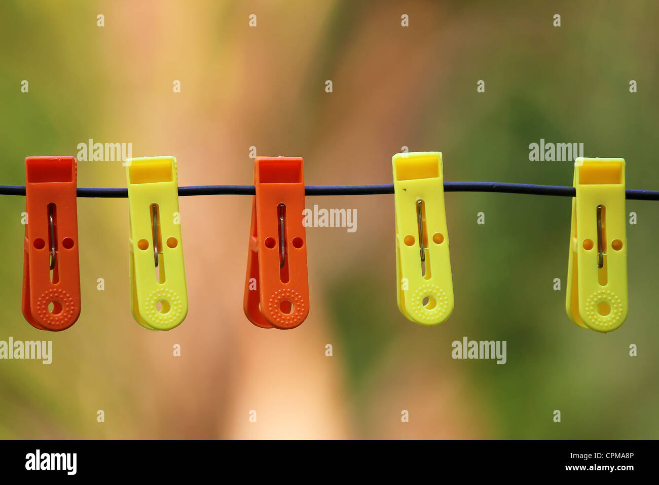 Plastic clothes pegs on washing line Stock Photo - Alamy