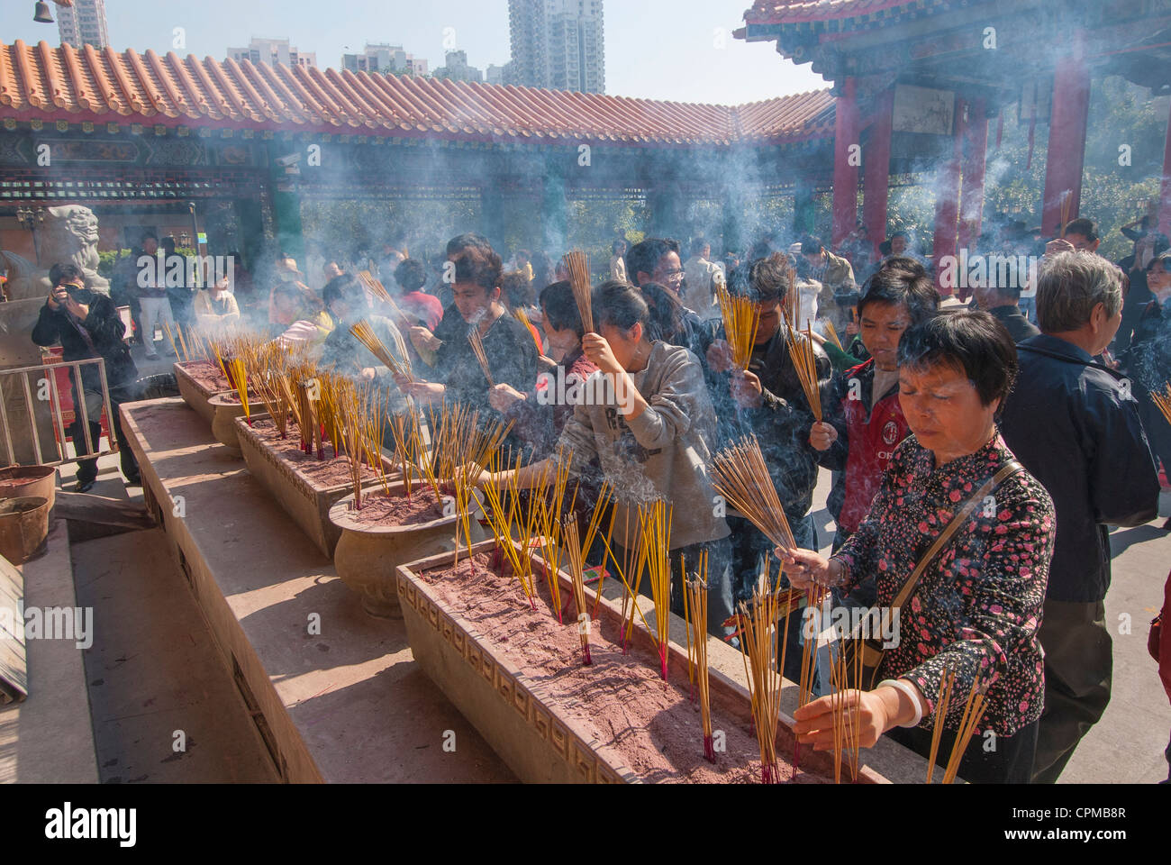Large crowds of people light incense for their ancestors at the Wong ...