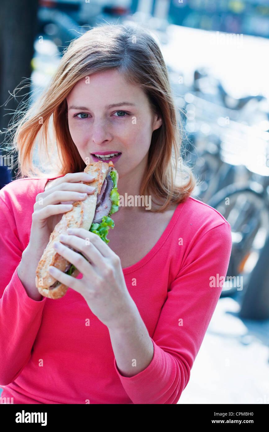 WOMAN EATING A SANDWICH Stock Photo - Alamy