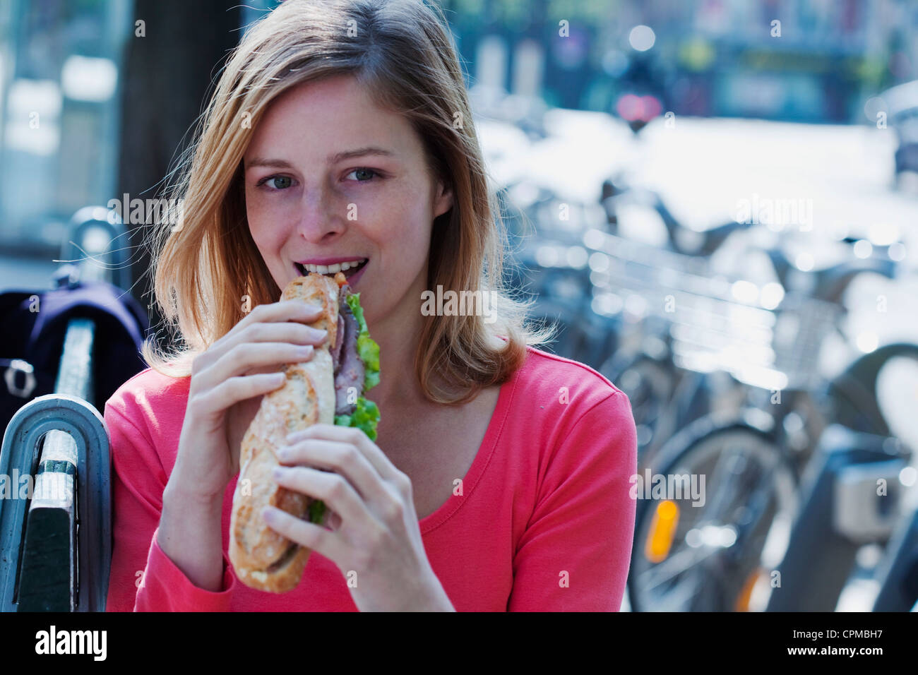 WOMAN EATING A SANDWICH Stock Photo - Alamy