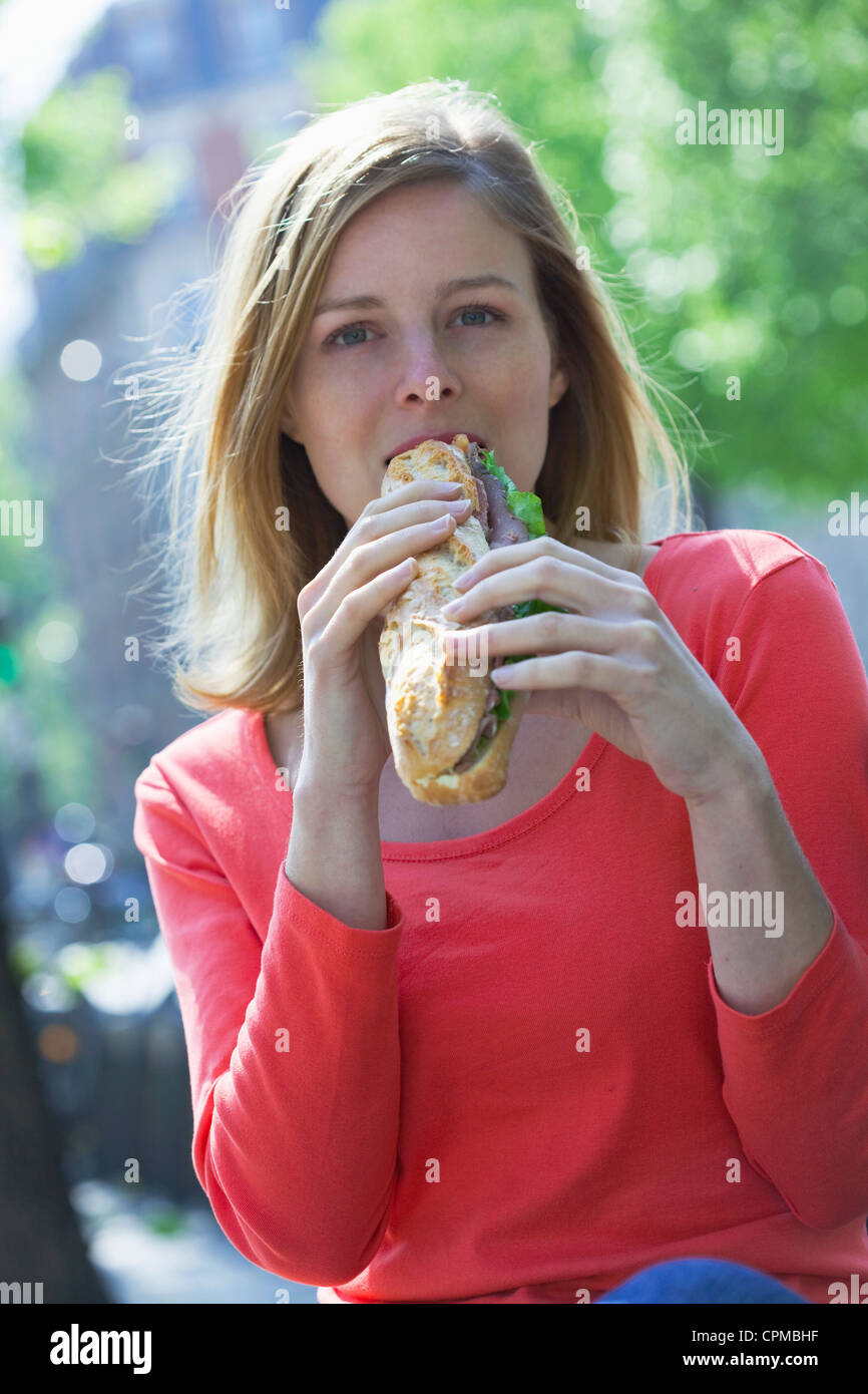WOMAN EATING A SANDWICH Stock Photo - Alamy