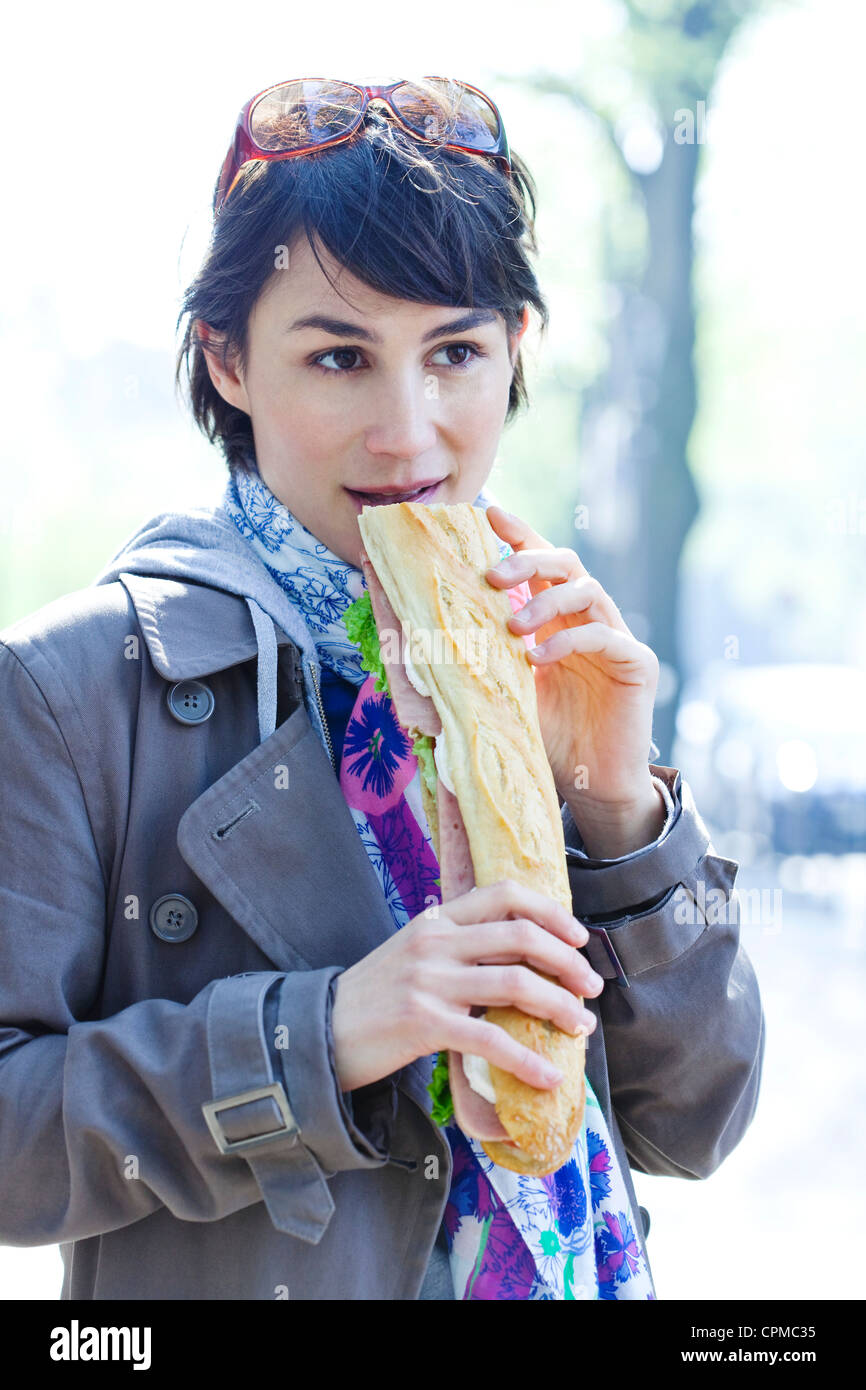 WOMAN EATING A SANDWICH Stock Photo - Alamy