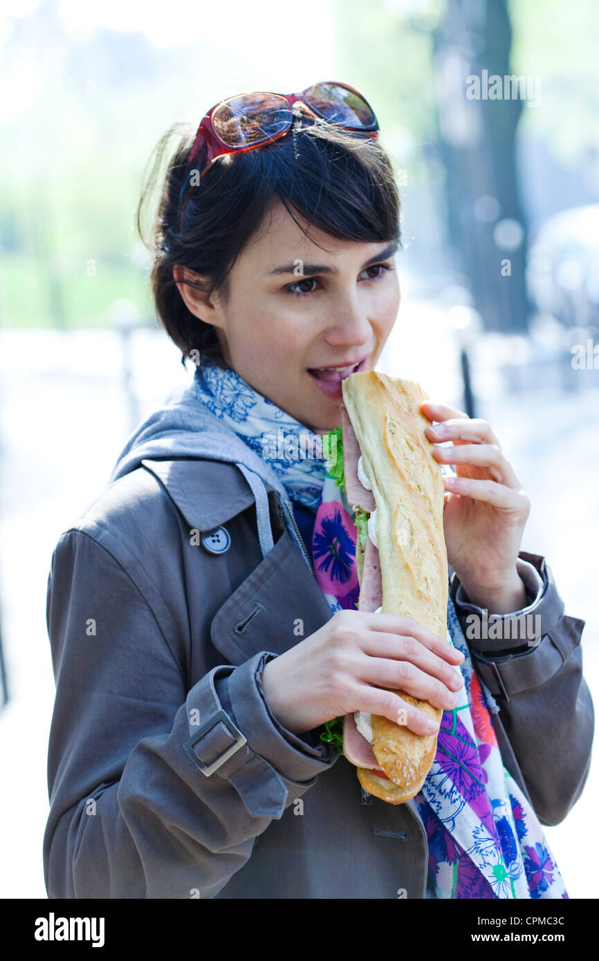 WOMAN EATING A SANDWICH Stock Photo - Alamy