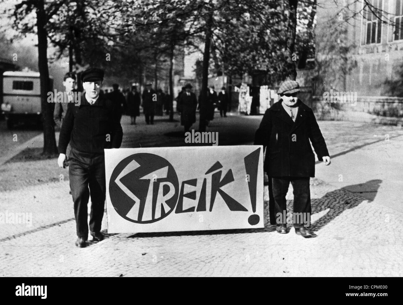 Workers with a strike poster in Berlin, 1930 Stock Photo - Alamy