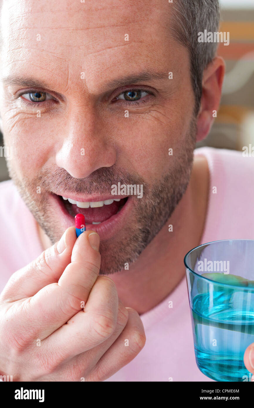 MAN TAKING MEDICATION Stock Photo - Alamy