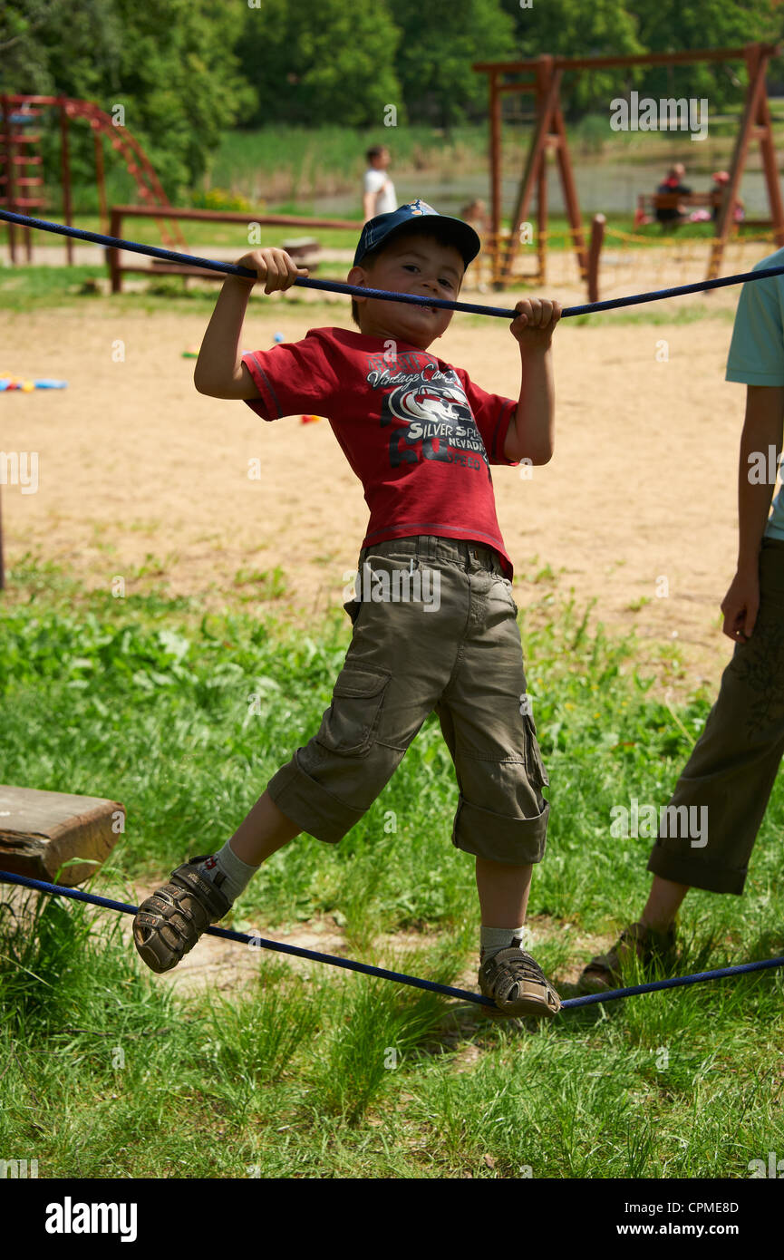 children training and walking on rope - slacline with mother summer ...