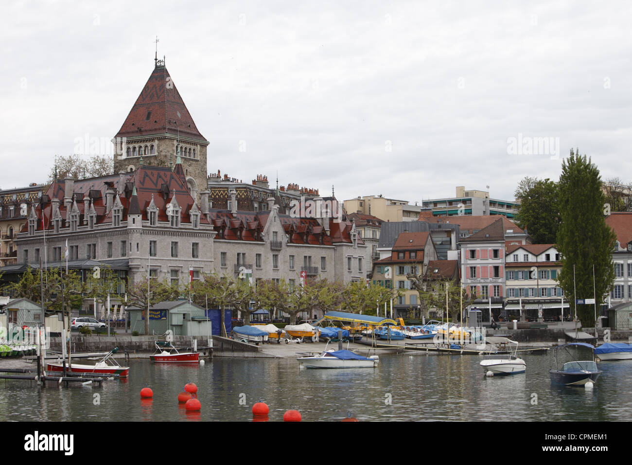 Chateau de Ouchy and tourist pleasure boats in Ouchy harbor on Lake ...