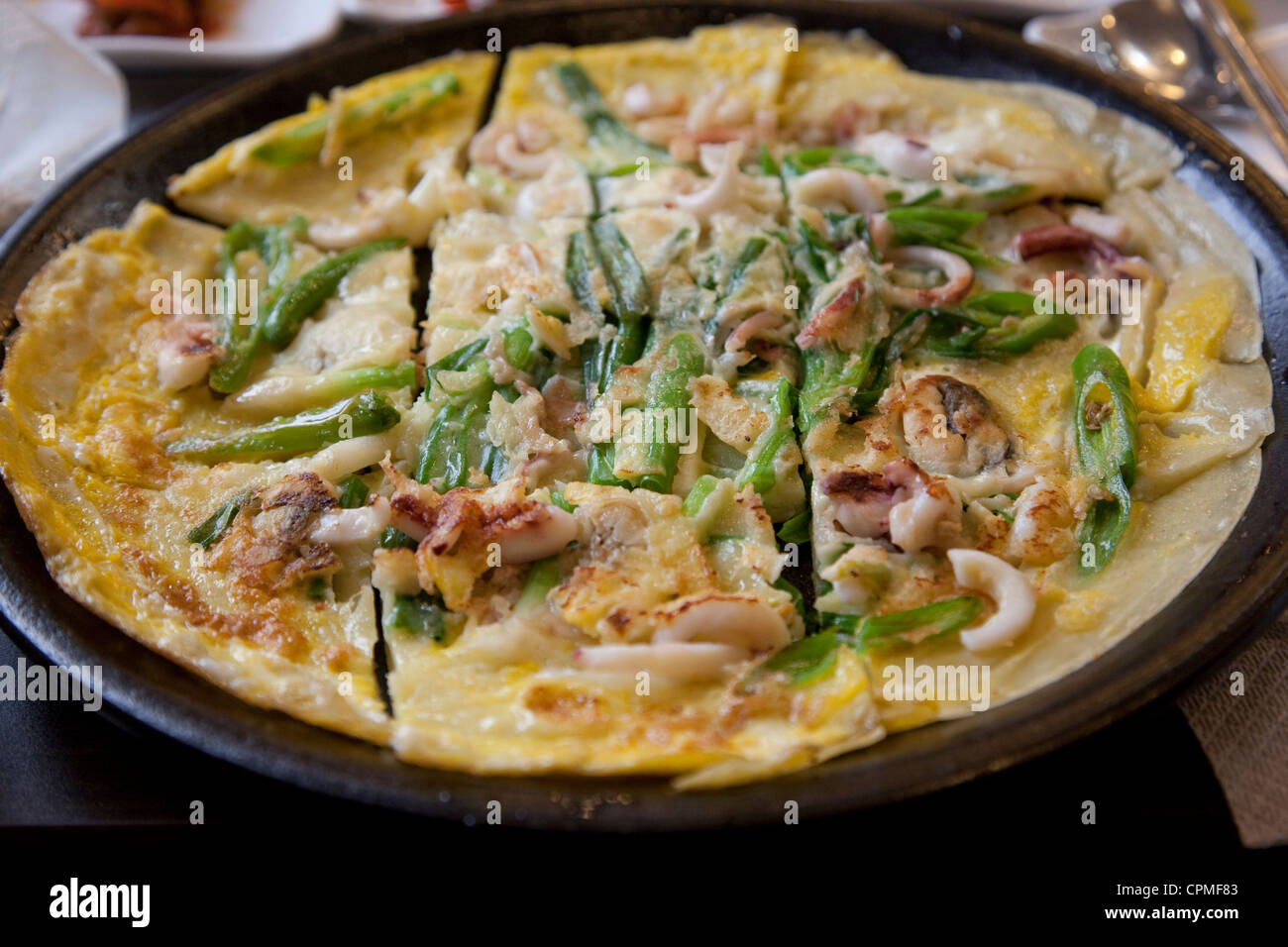 Haemul pajeon (seafood pancake) with green onions is a popular Korean ...