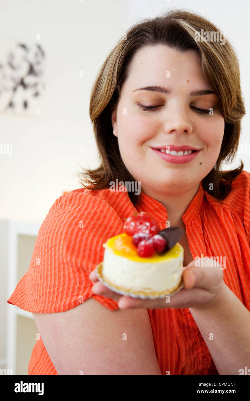 WOMAN EATING SWEETS Stock Photo - Alamy