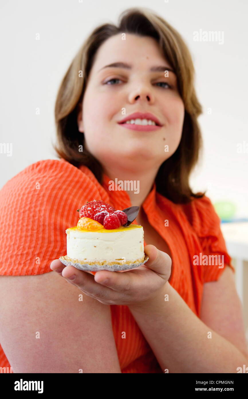 WOMAN EATING SWEETS Stock Photo - Alamy