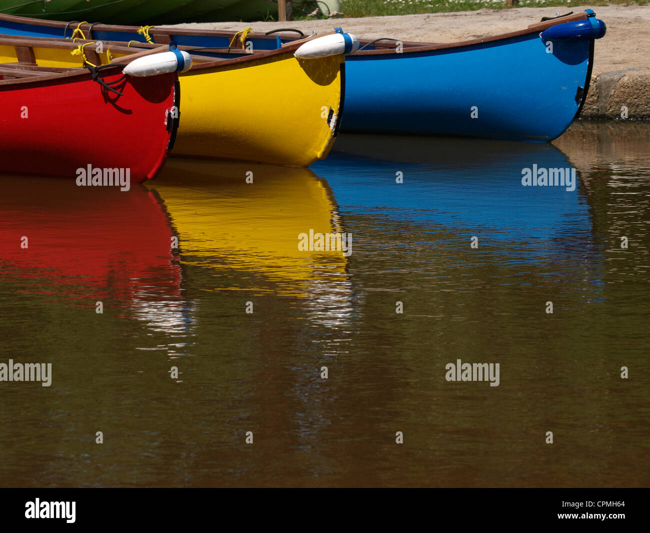 Three colourful canoes, UK Stock Photo - Alamy