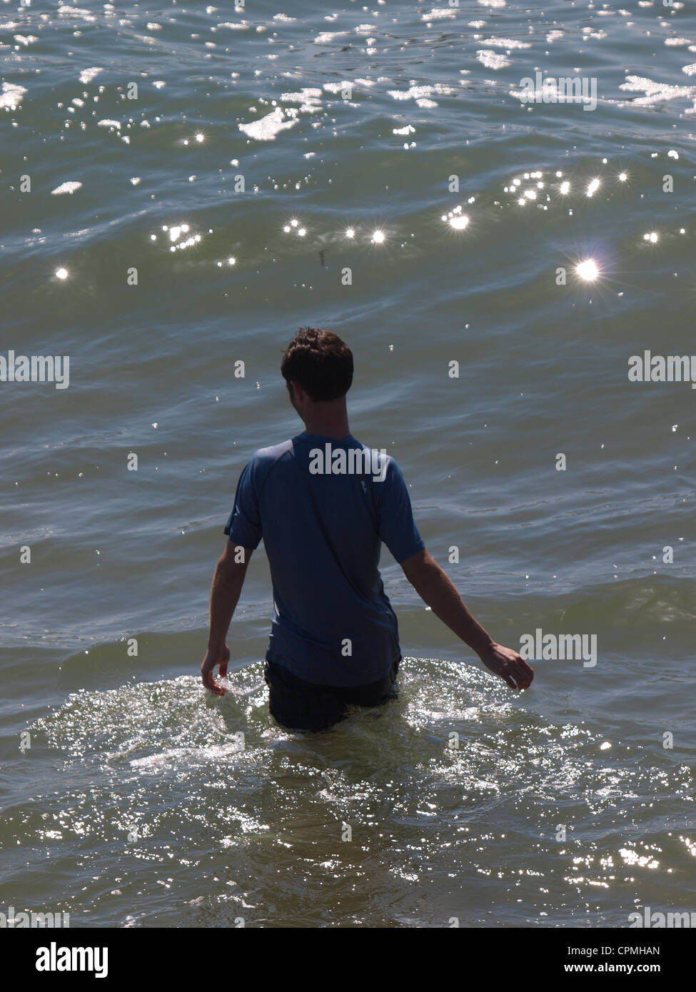 Man wading into the sea, Cornwall, UK Stock Photo - Alamy