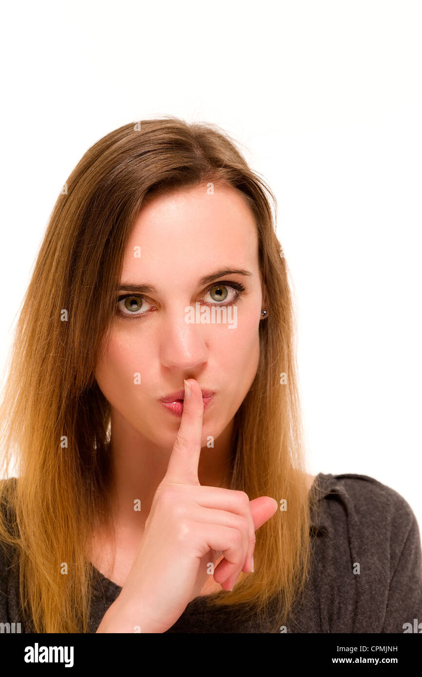 woman holding a finger to her mouth to shh on white background Stock ...