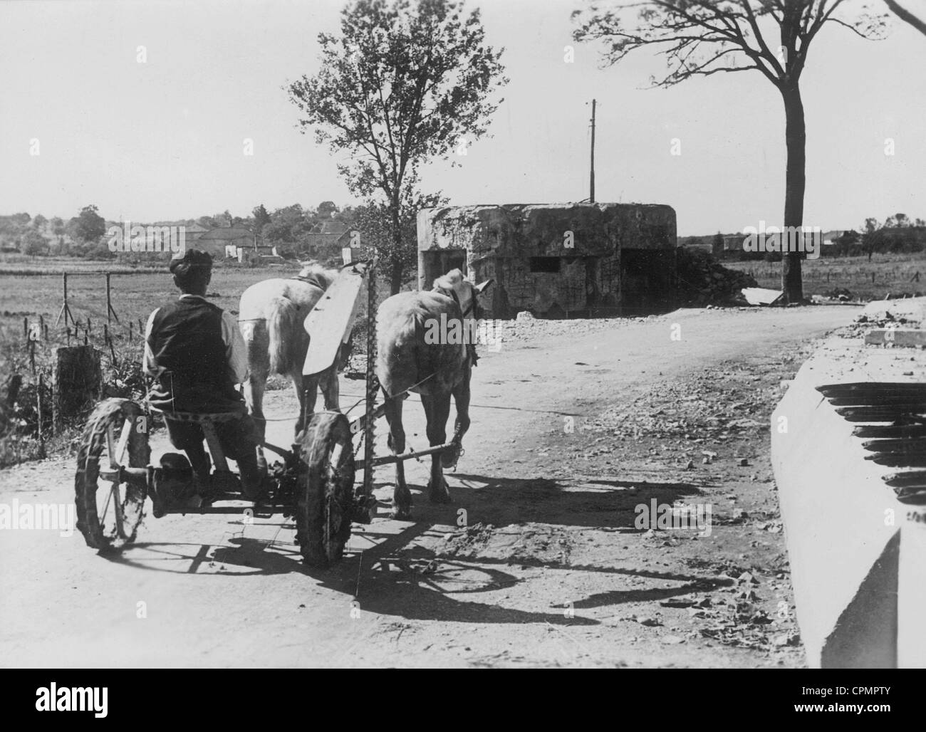French farmers with team of horses, in the background a destroyed ...