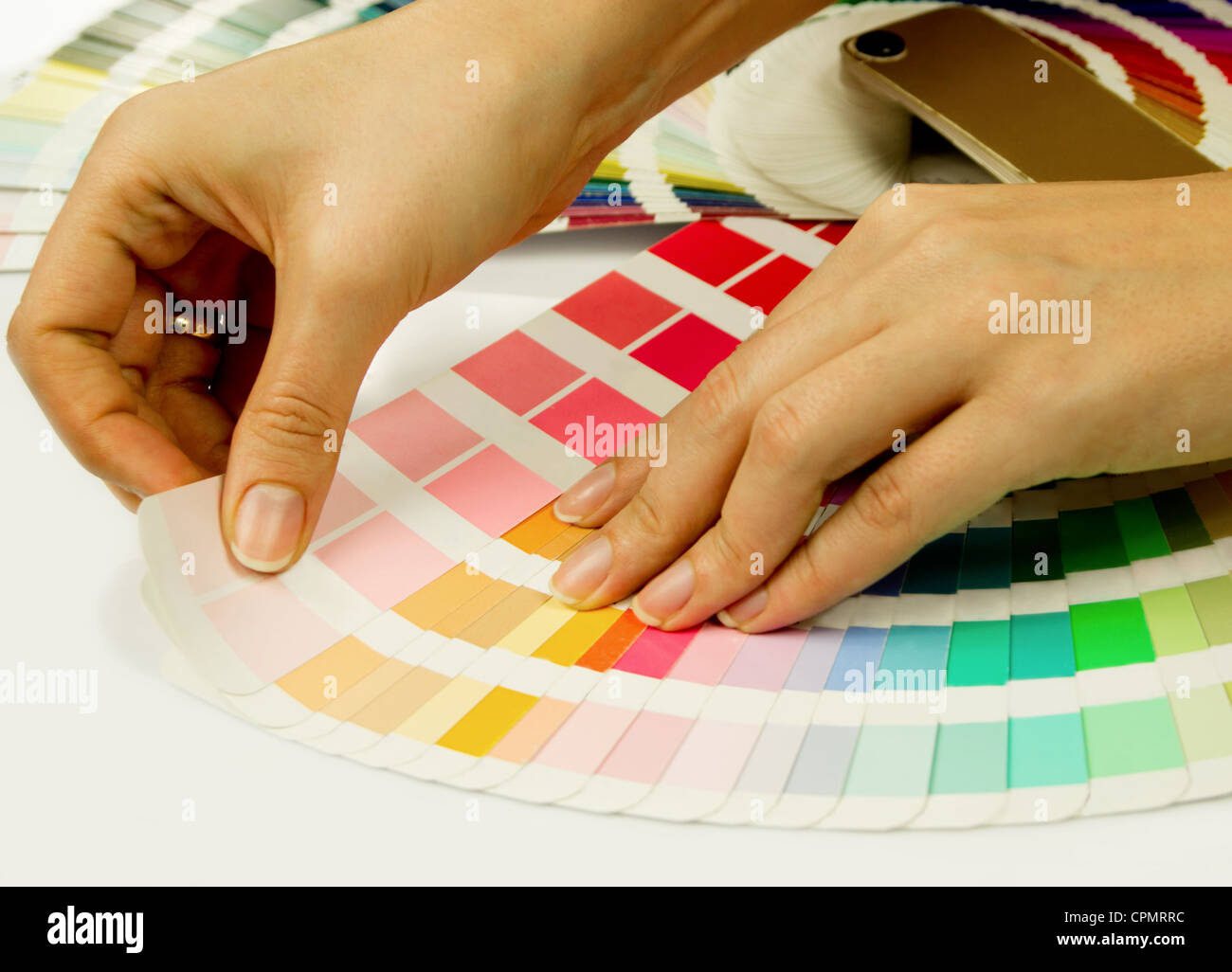 Woman selecting color from Pantone swatches book Stock Photo - Alamy