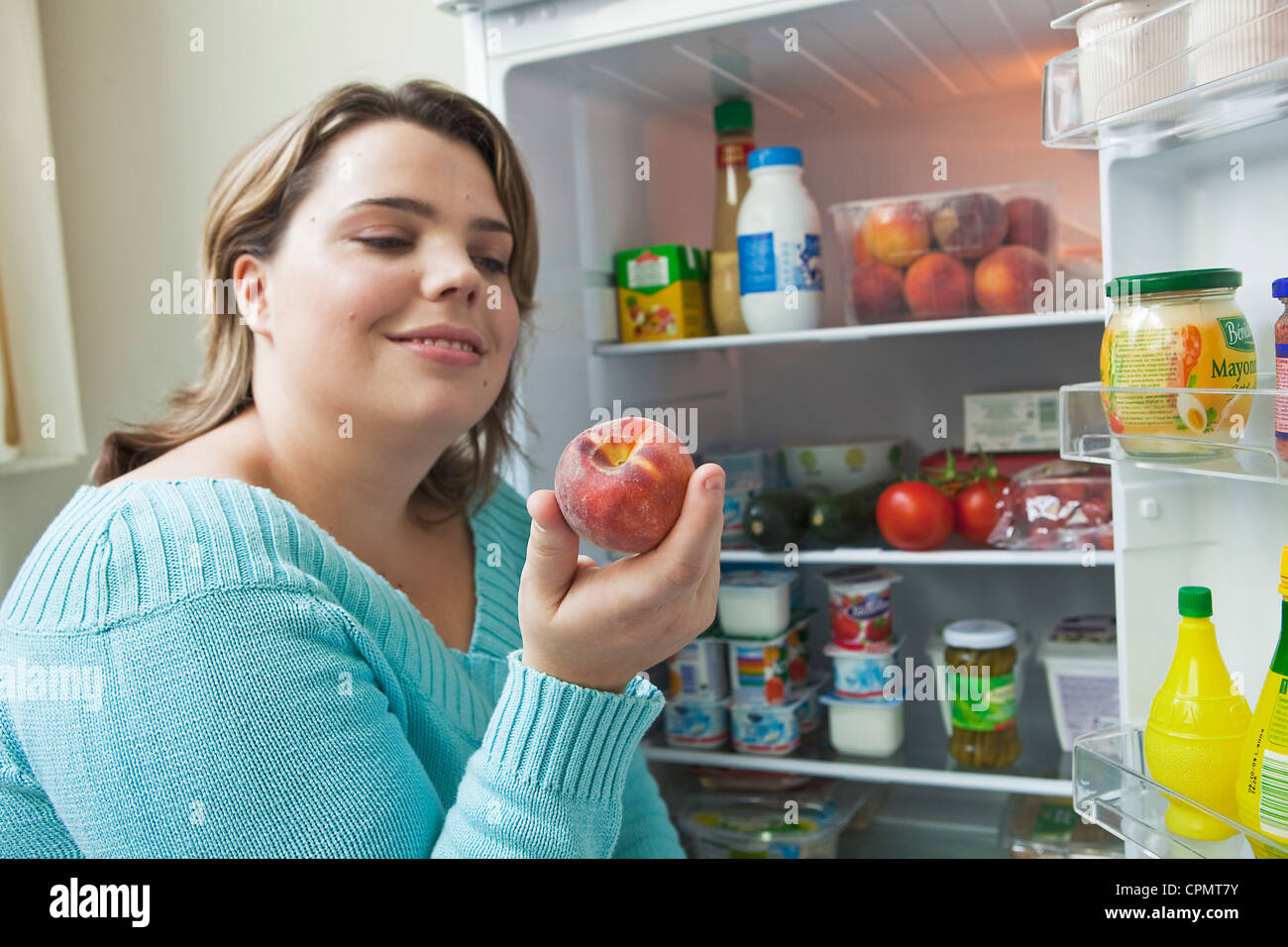 WOMAN EATING FRUIT Stock Photo - Alamy