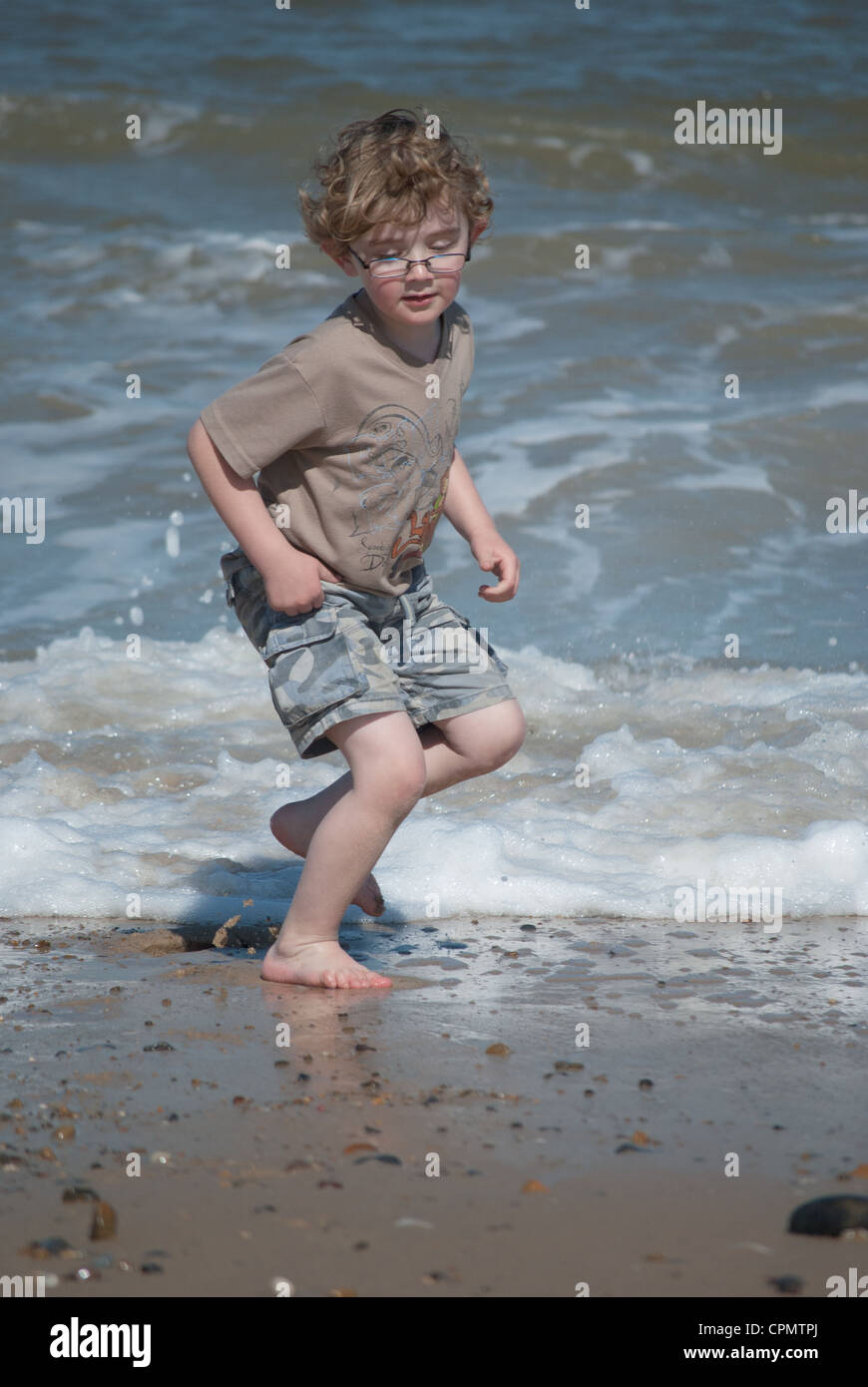 A small boy playing on the beach Stock Photo - Alamy