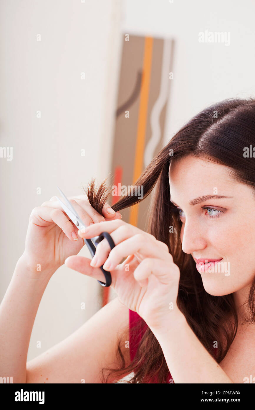 Woman cutting her own hair hi-res stock photography and images - Alamy