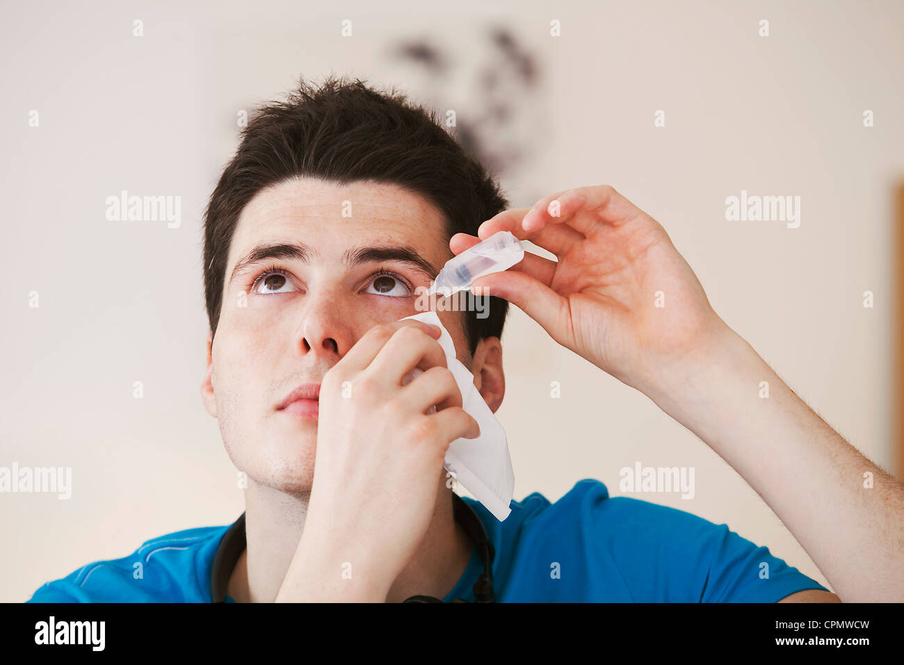 ADOLESCENT USING EYE LOTION Stock Photo - Alamy