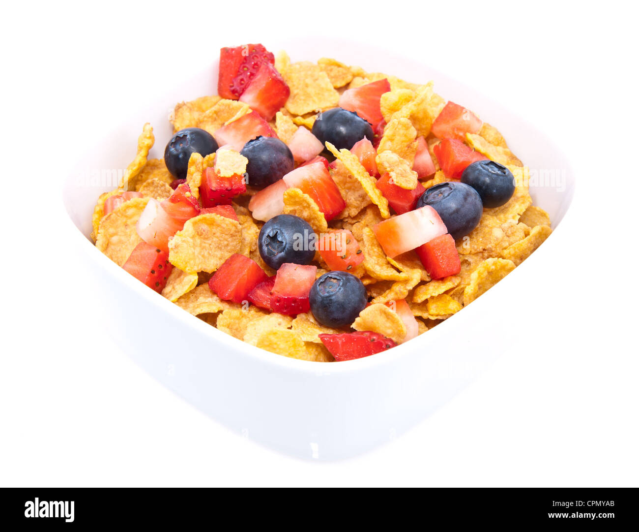 Cornflakes with fresh fruits in a bowl isolated on white background ...