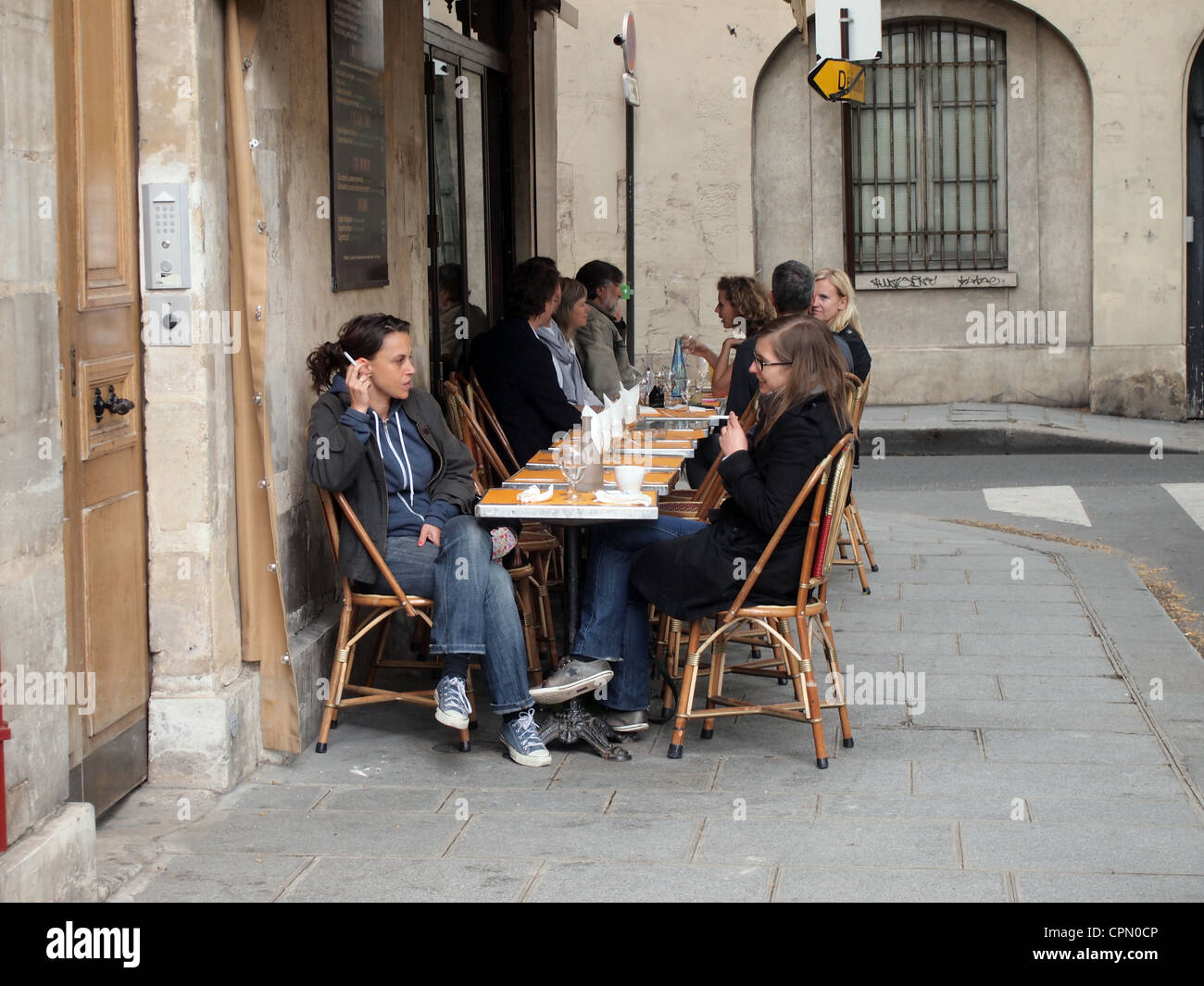 People sitting outside at a paris cafe restaurant hi-res stock ...