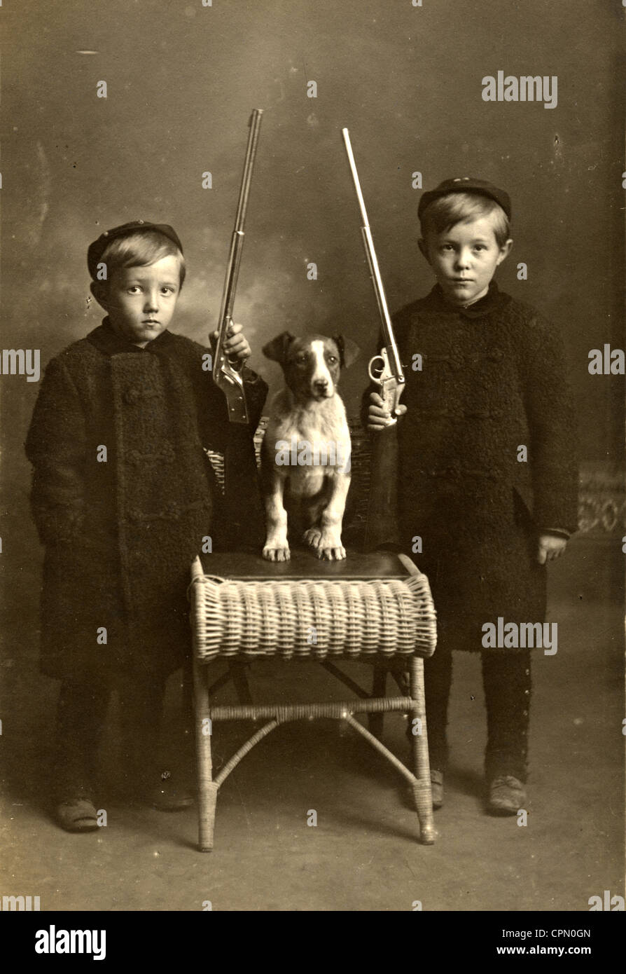 Two Young Brothers with Toy BB Guns Flanking Beagle Stock Photo - Alamy