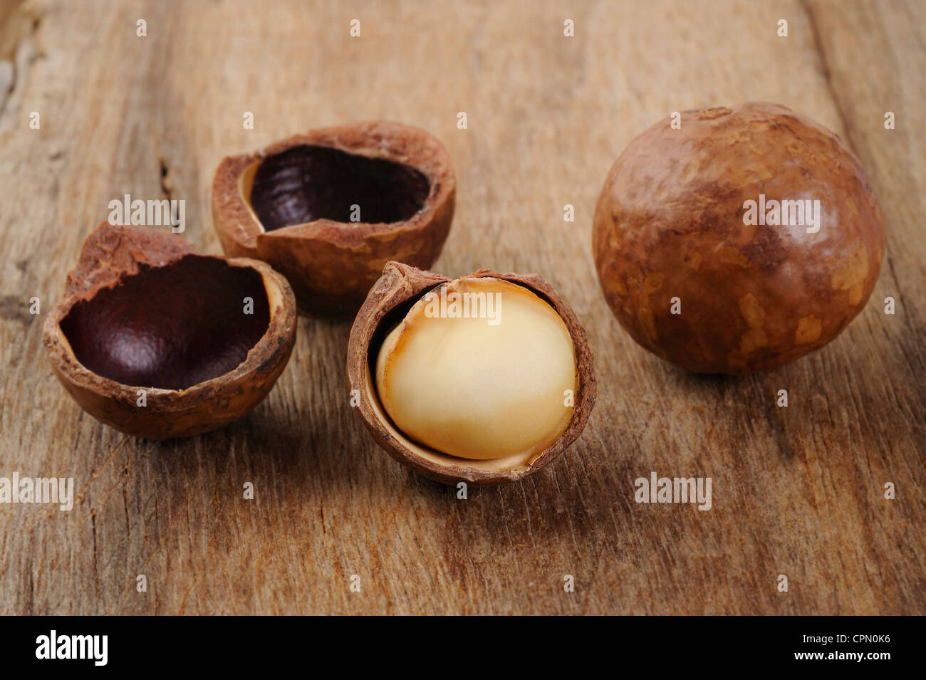 cracked macadamia on wood background Stock Photo - Alamy