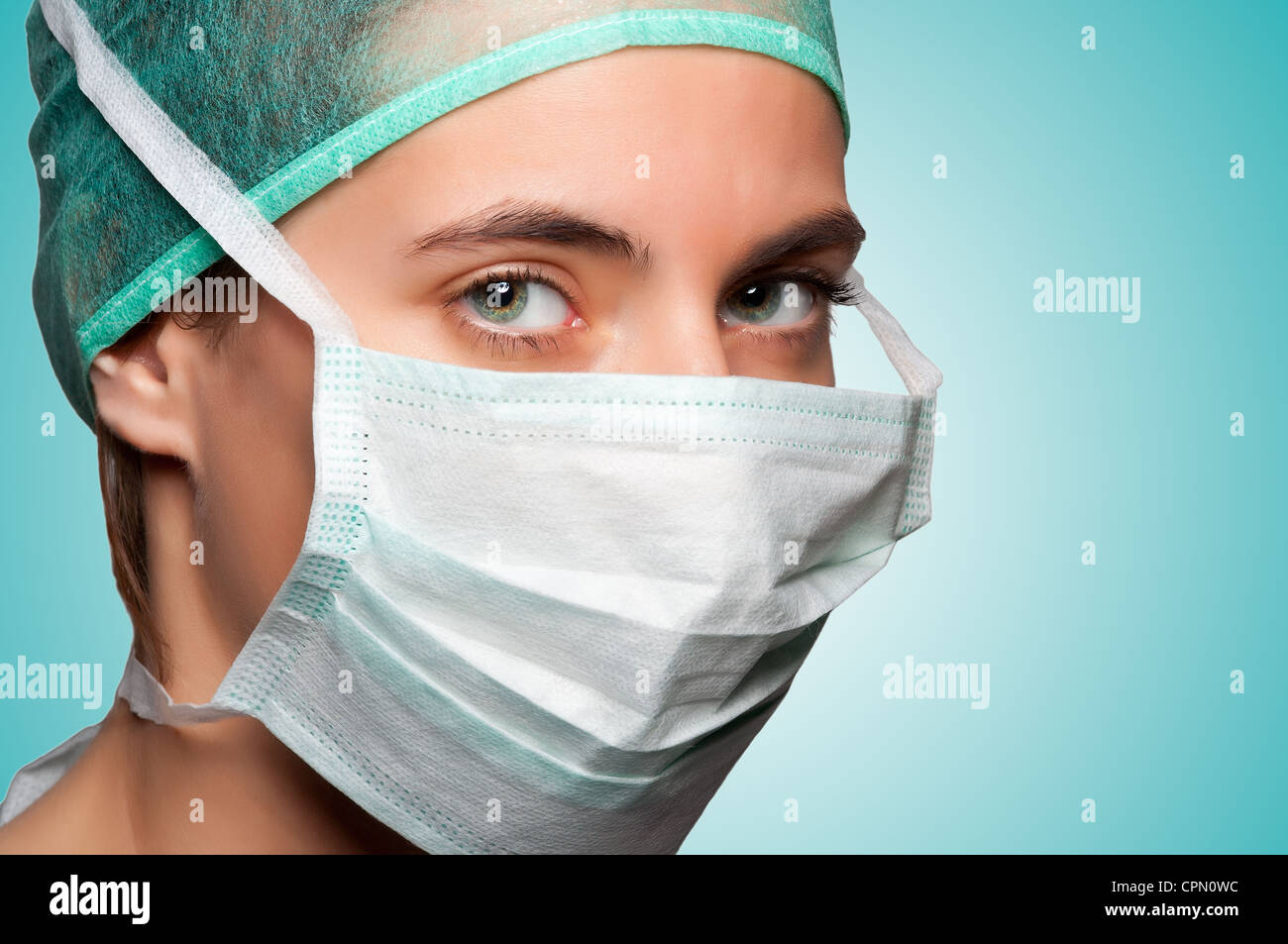 Closeup portrait of a female surgeon in a green background Stock Photo ...