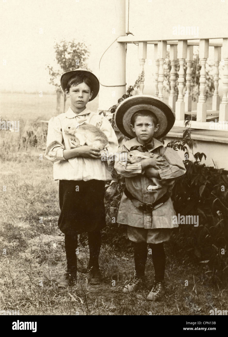 Two Young Brothers Each Holding a Pet Rabbit Stock Photo - Alamy