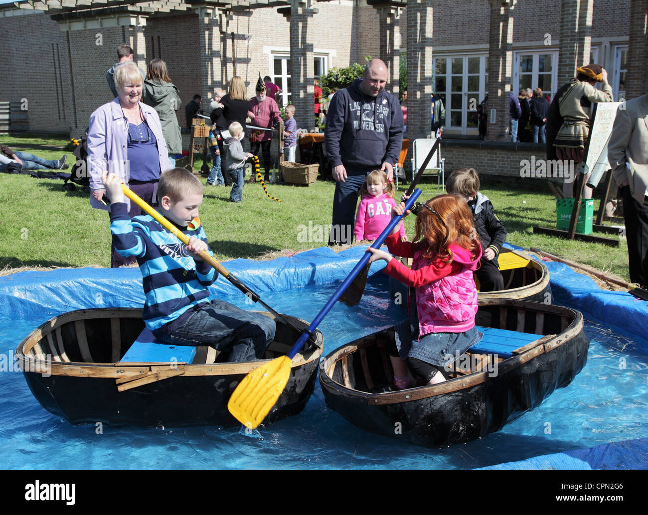 Children playing in coracles at Bede's World farm, Jarrow, North East ...