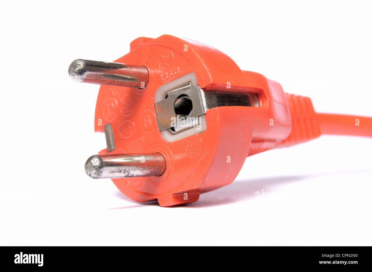 Orange colored power plug on white background Stock Photo - Alamy