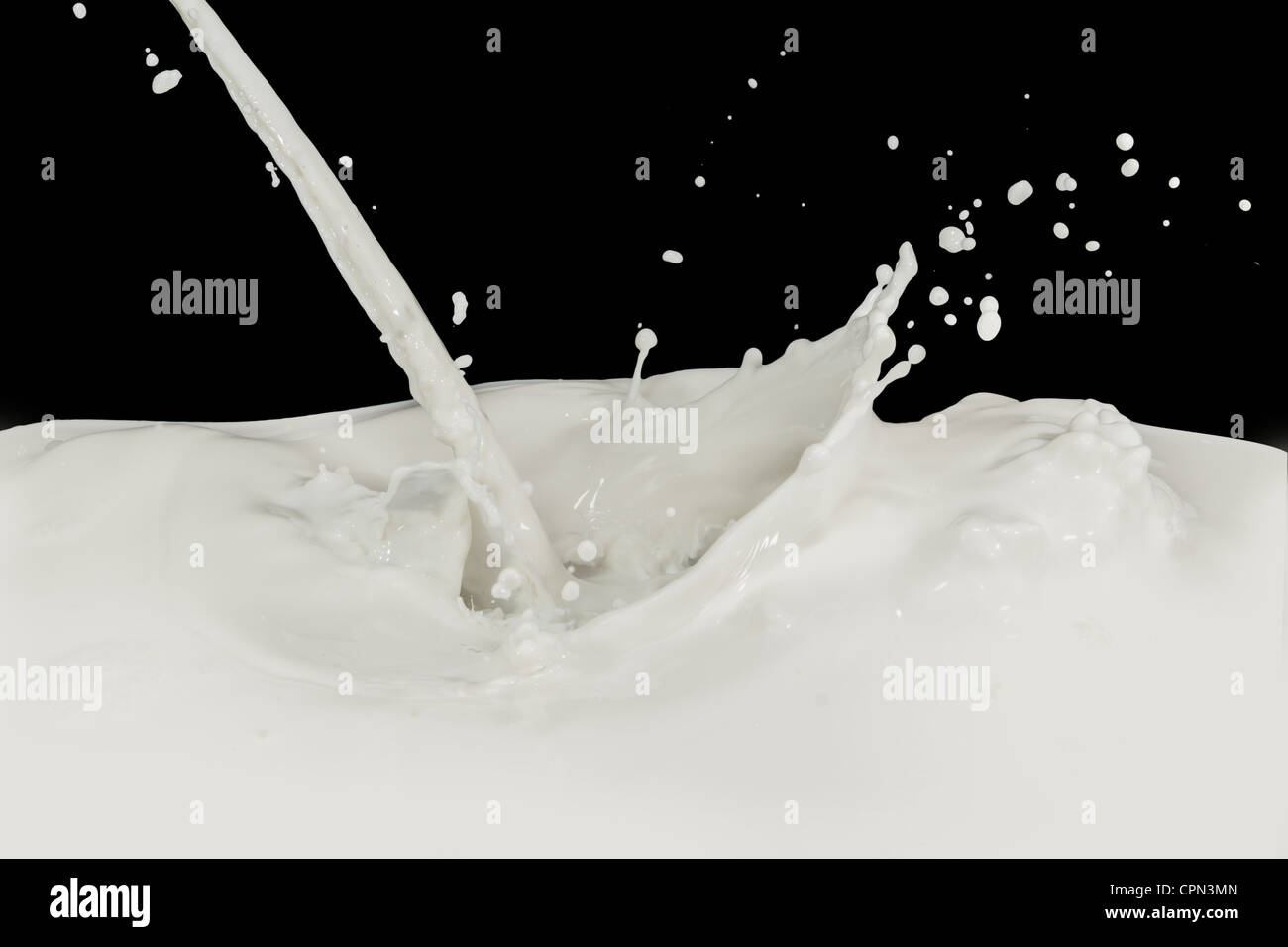 splashing milk isolated on black background Stock Photo - Alamy