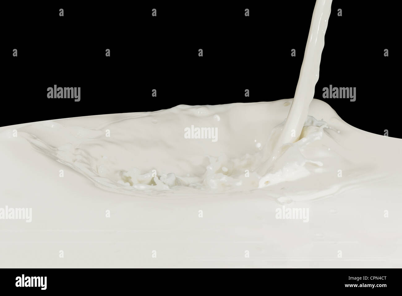 splashing milk isolated on black background Stock Photo - Alamy