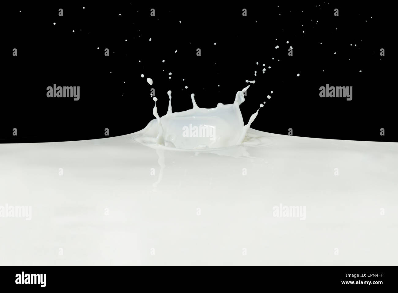 splashing milk isolated on black background Stock Photo - Alamy