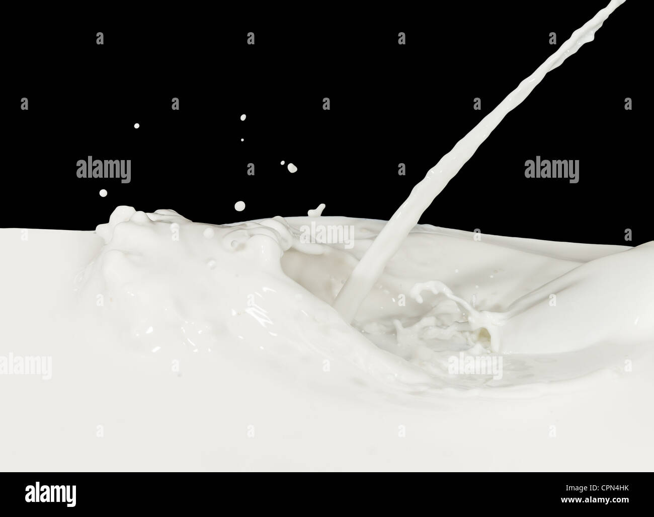 splashing milk isolated on black background Stock Photo - Alamy