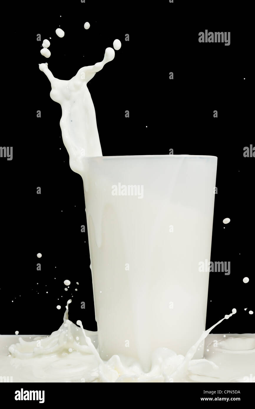 milk splashing from the glass Stock Photo - Alamy