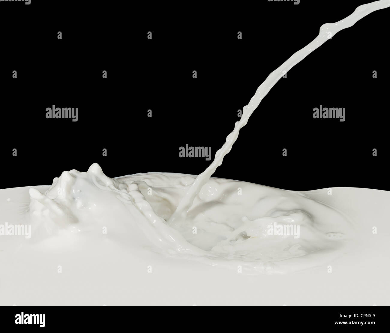 splashing milk isolated on black background Stock Photo - Alamy