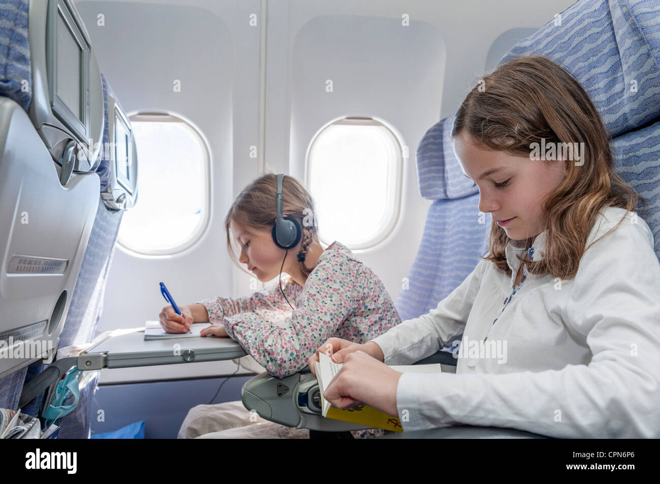 Girls on airplane Stock Photo - Alamy