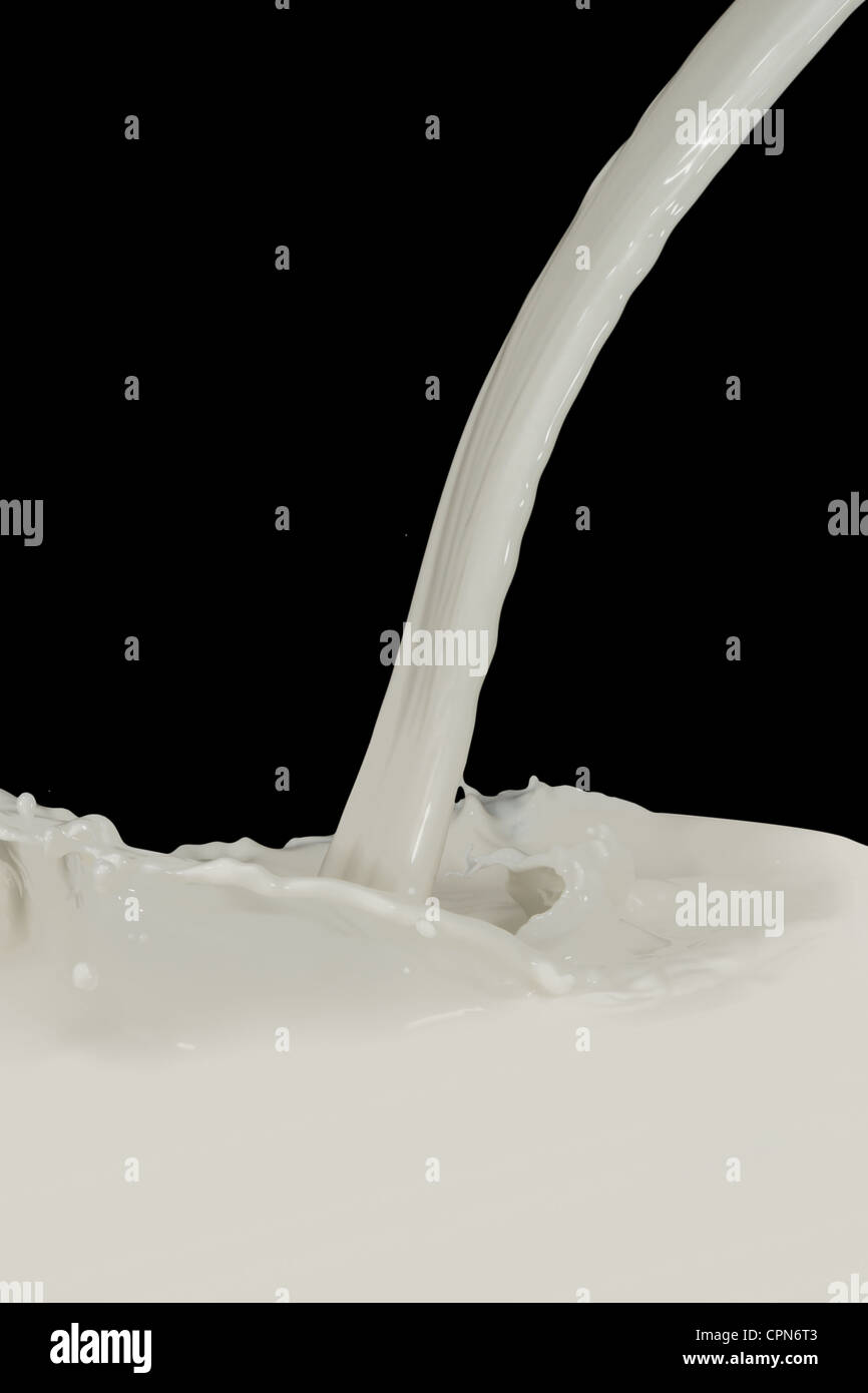 splashing milk isolated on black background Stock Photo - Alamy