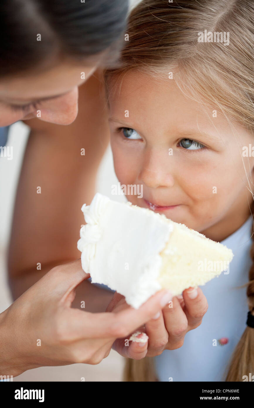 Mother feeding little girl cake Stock Photo - Alamy