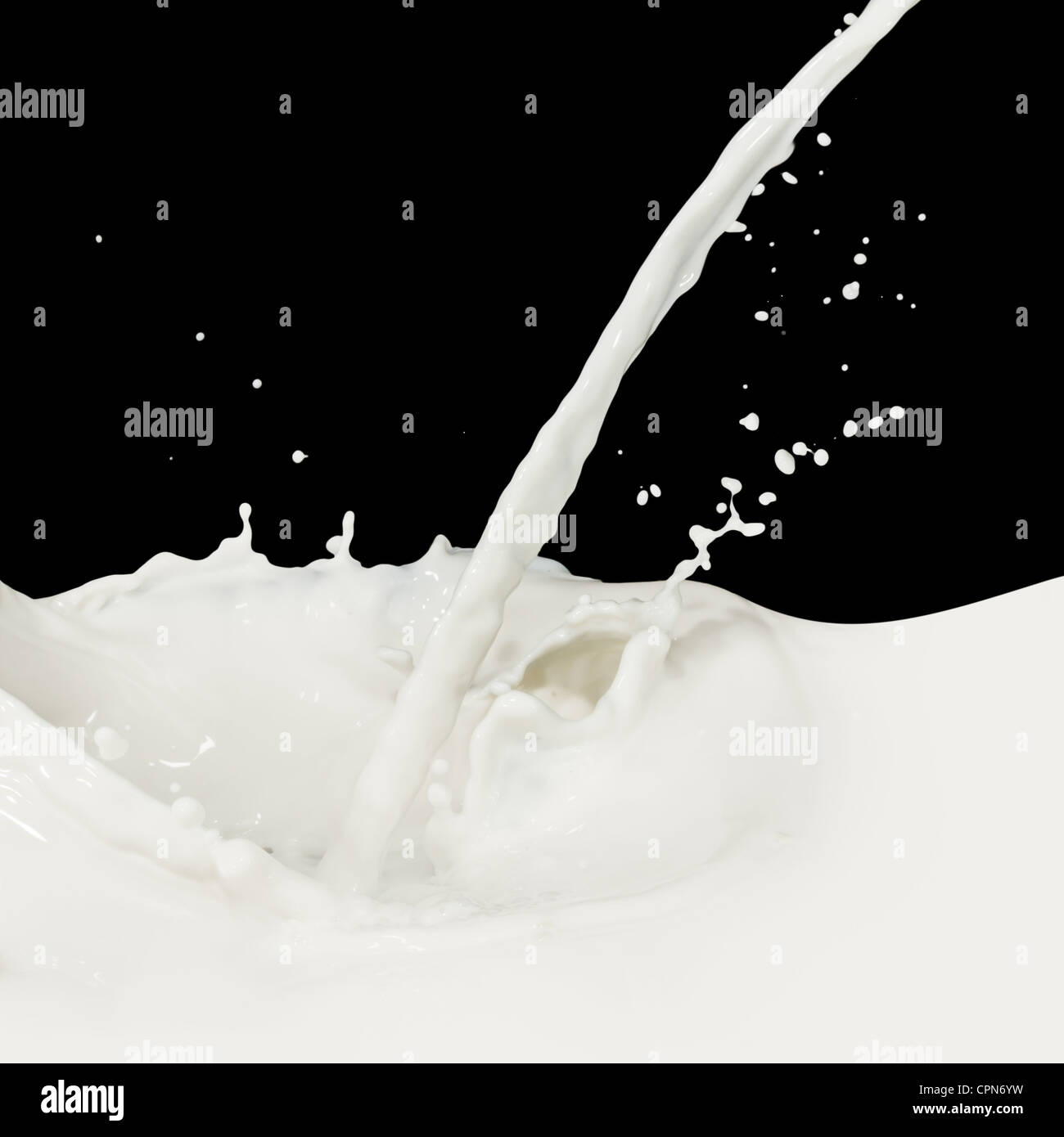 splashing milk isolated on black background Stock Photo - Alamy