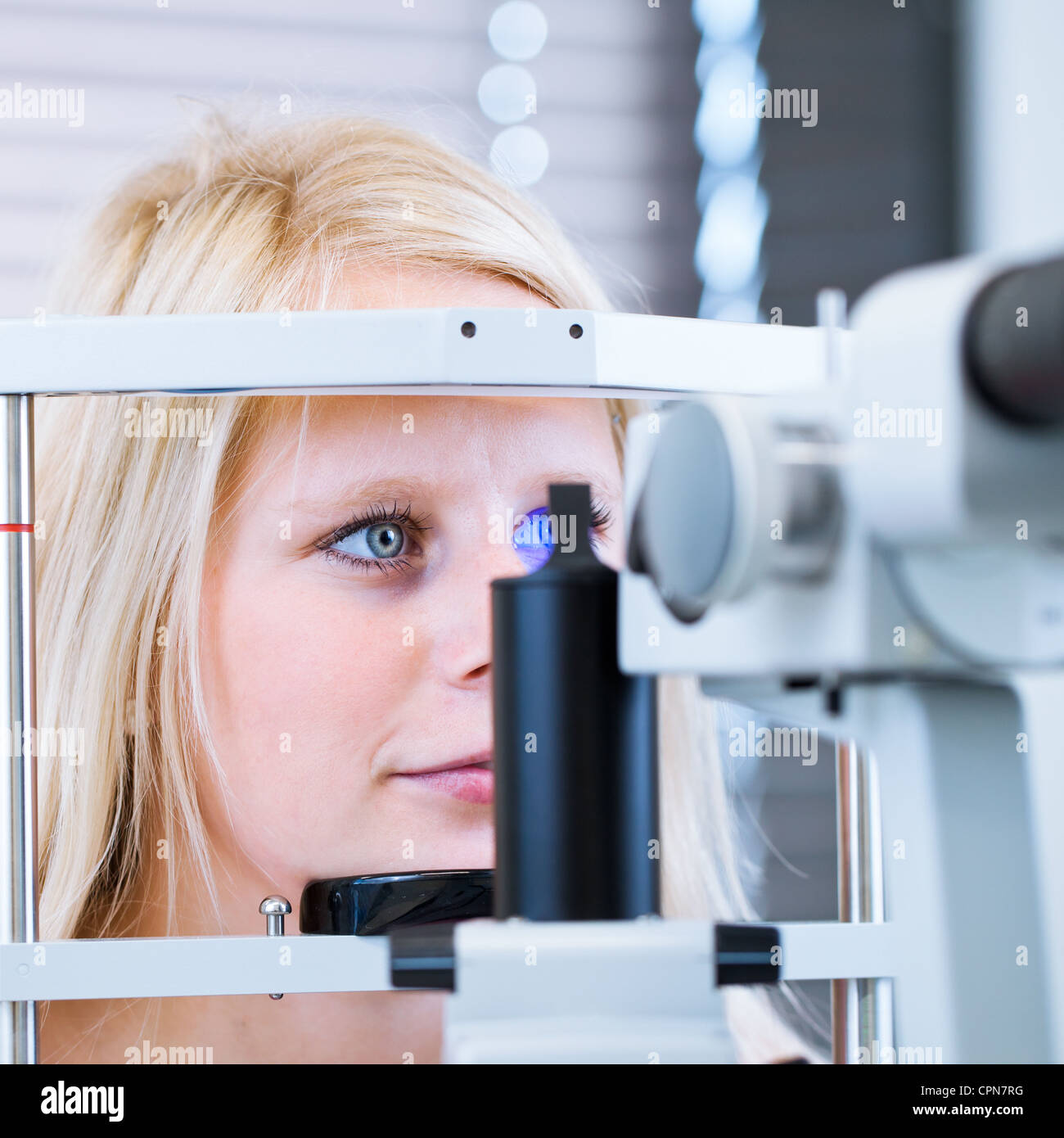 optometry concept - pretty, young female patient having her eyes ...