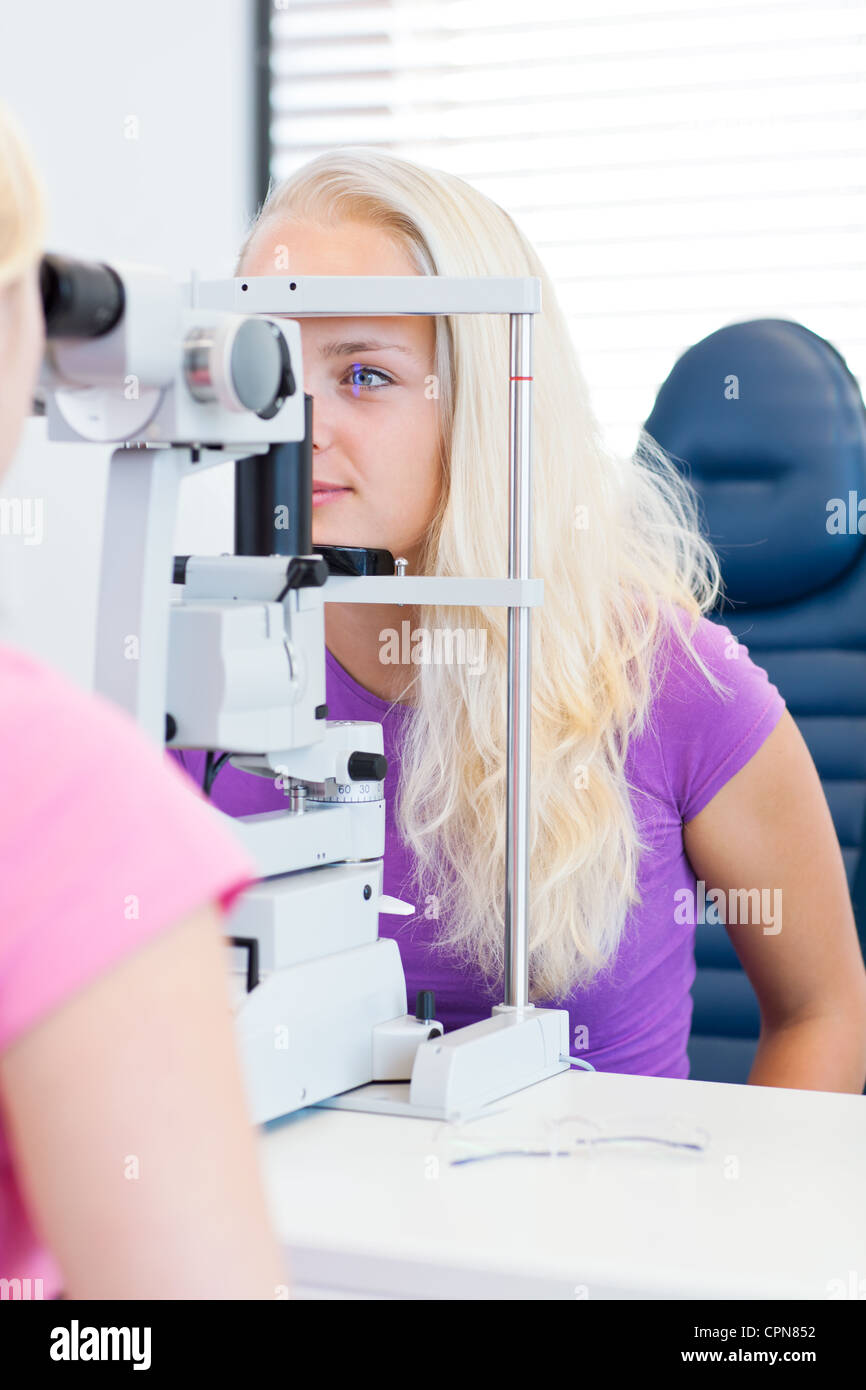 optometry concept - pretty, young female patient having her eyes ...