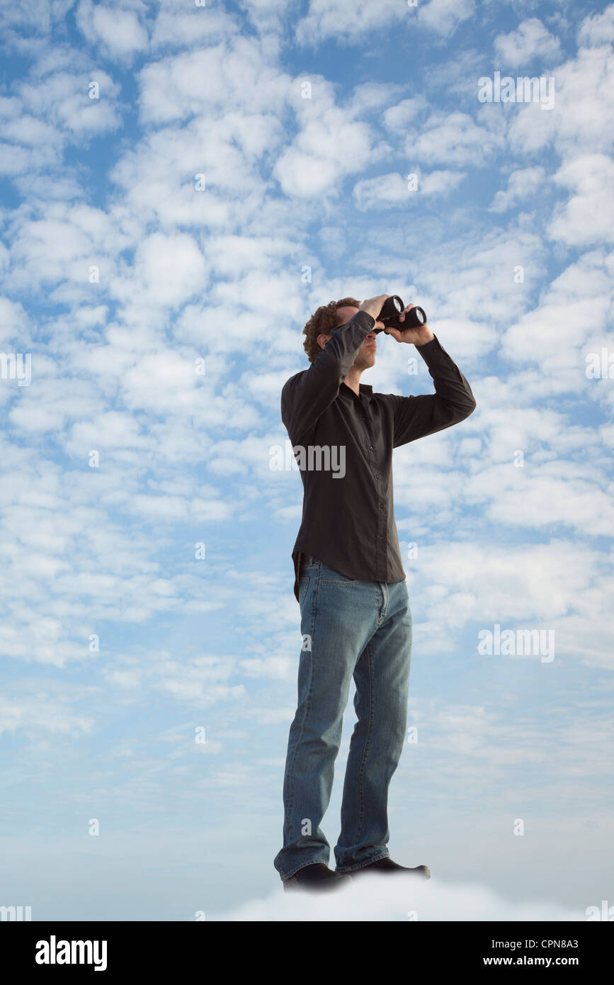 Man standing on cloud, looking through binoculars Stock Photo - Alamy